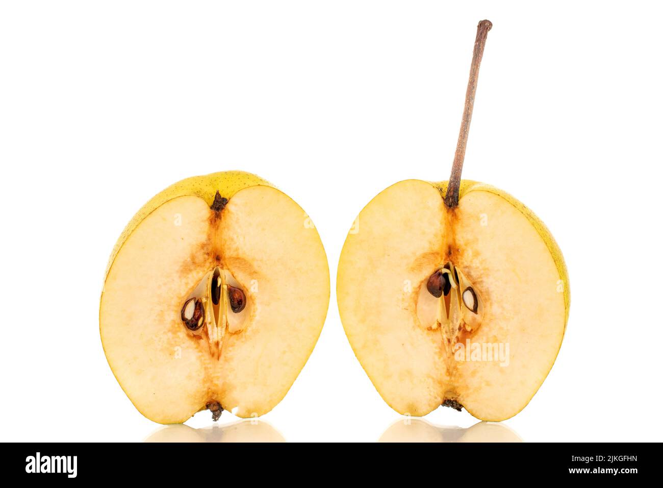 Two halves of a juicy yellow pear, close-up, isolated on a white ...