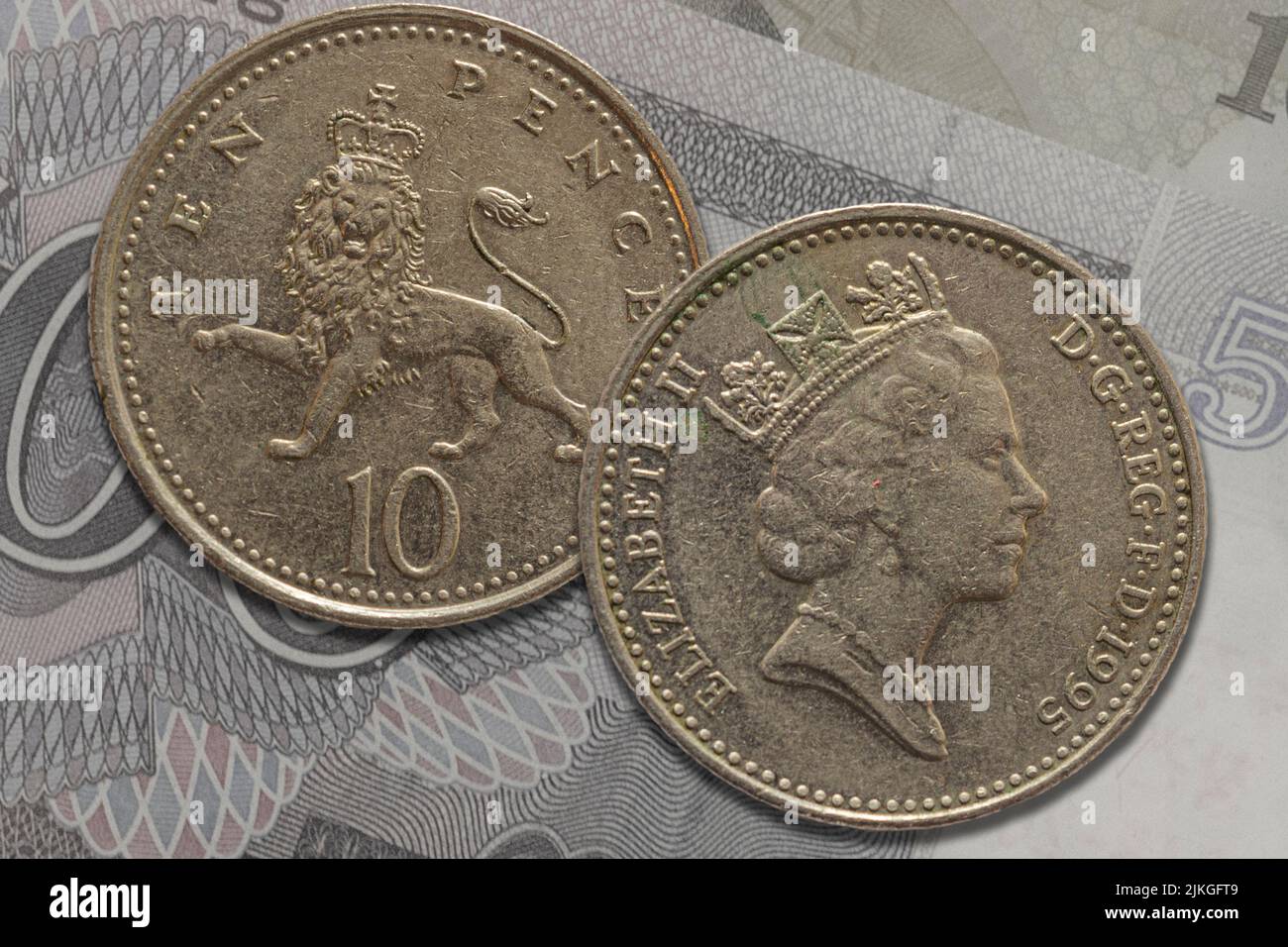 A top view closeup of British coins obverse and reverse on a paper ...
