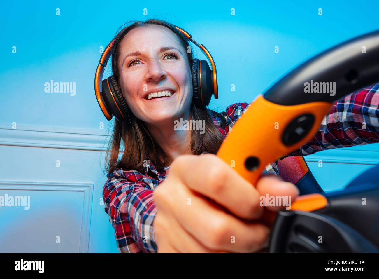 Portrait with console steering wheel of a laughing gamer woman Stock ...