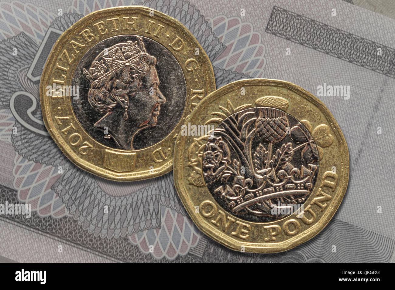 A top view closeup of British coins obverse and reverse on a paper ...
