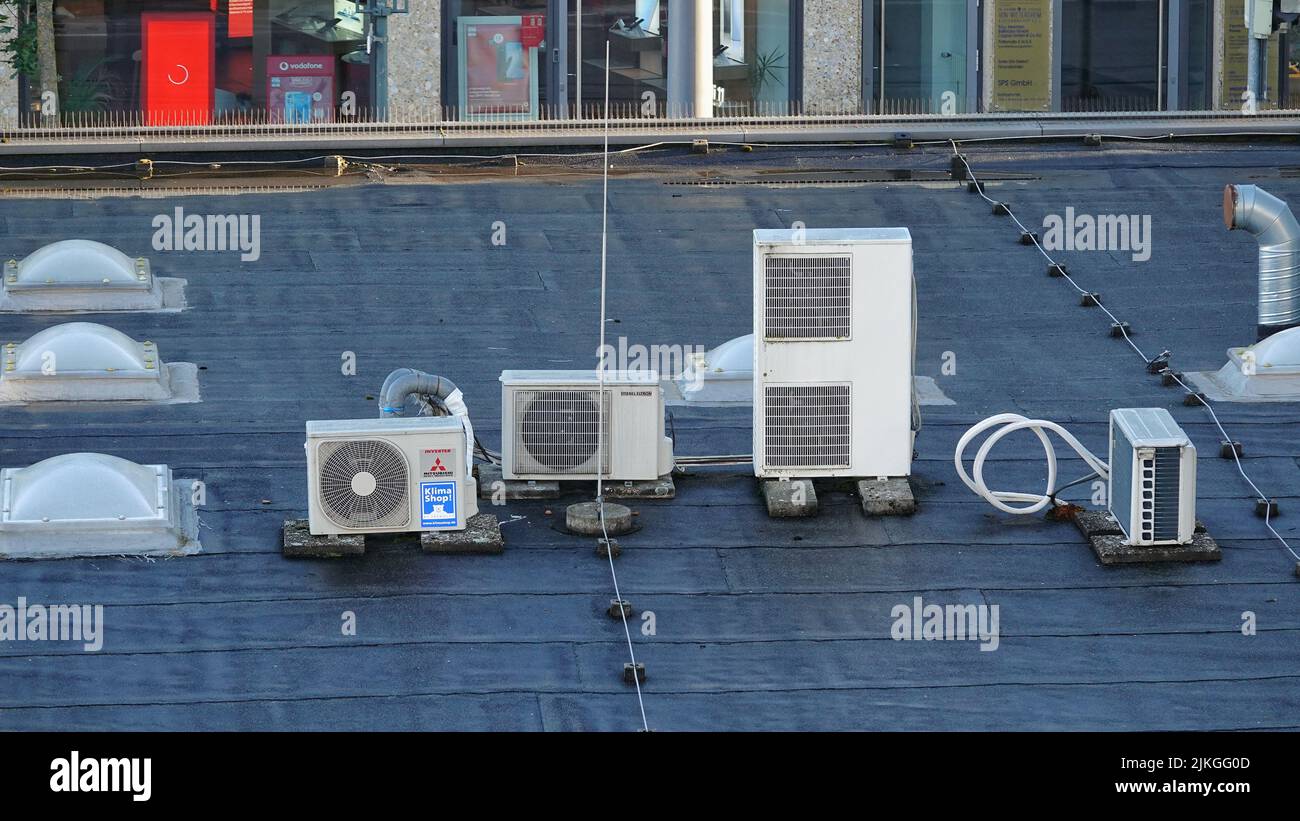Picture shows some outdoor units of air conditioners on a house roof ...