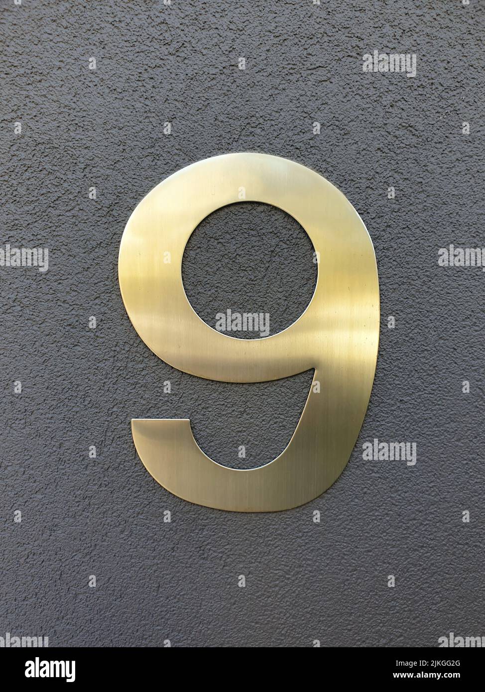 modern house number 9 outdoors on grey rendered wall Stock Photo - Alamy
