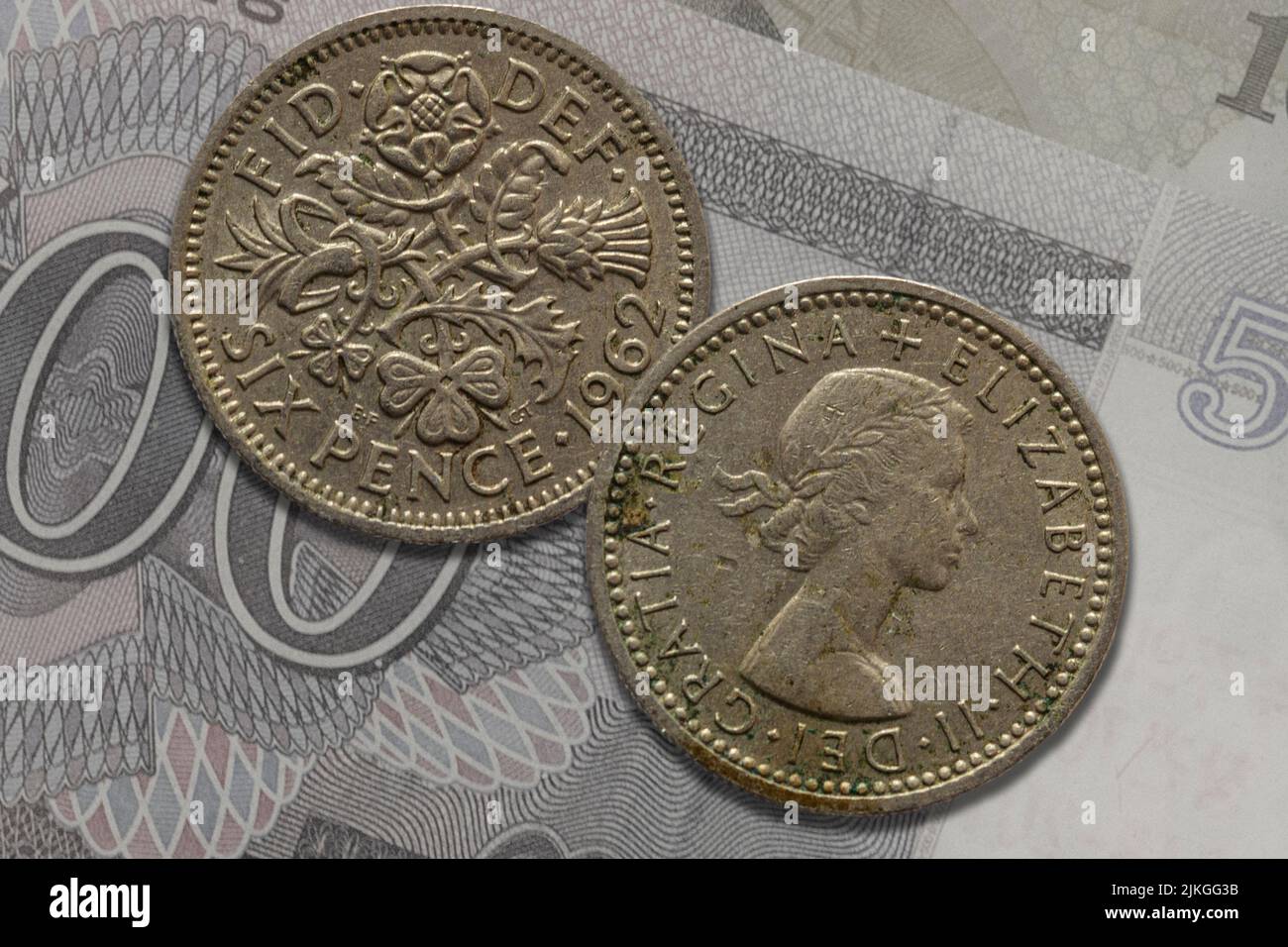 A top view closeup of British coins obverse and reverse on a paper ...
