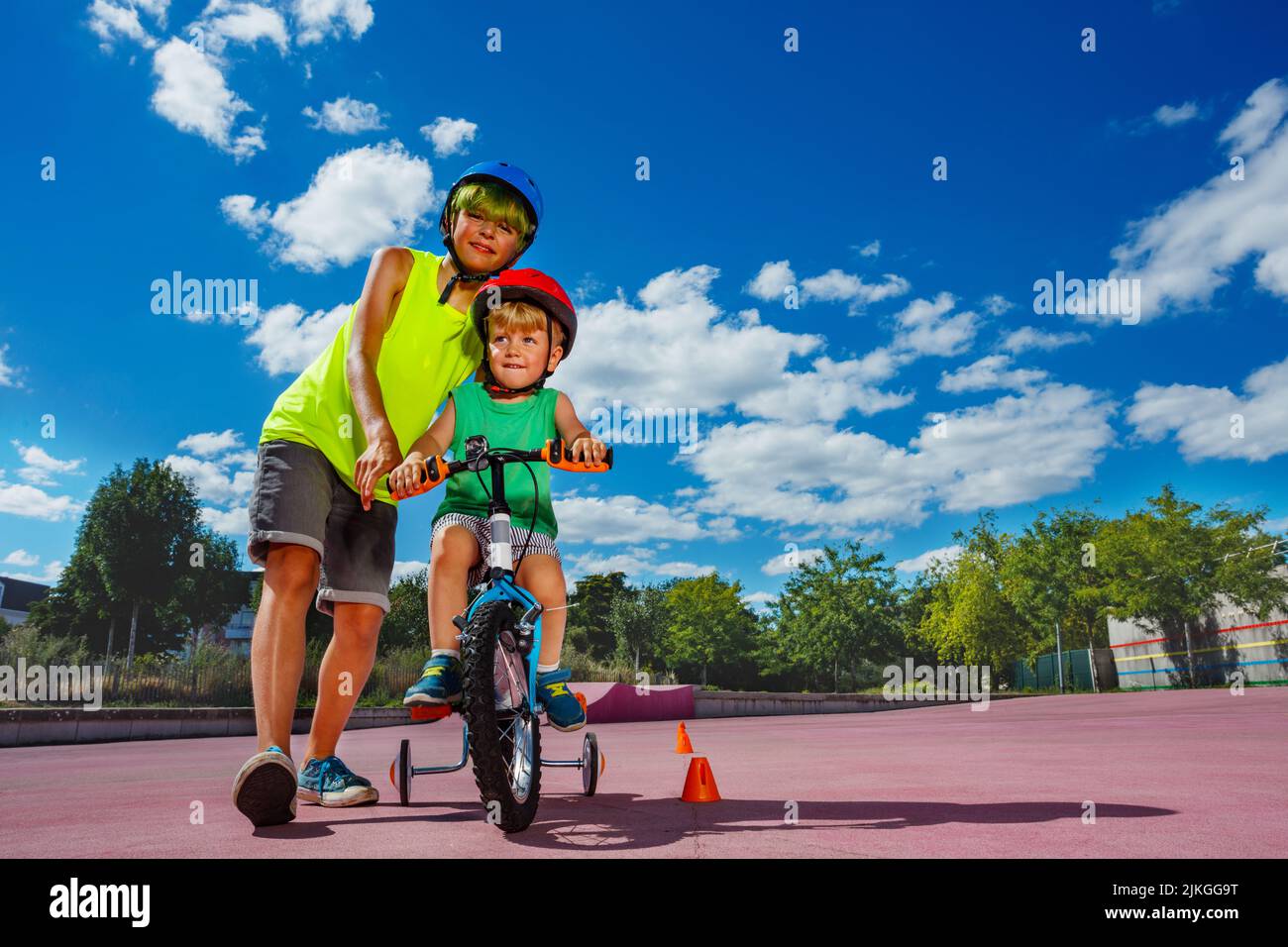 Boy pushing bicycle hi-res stock photography and images - Alamy