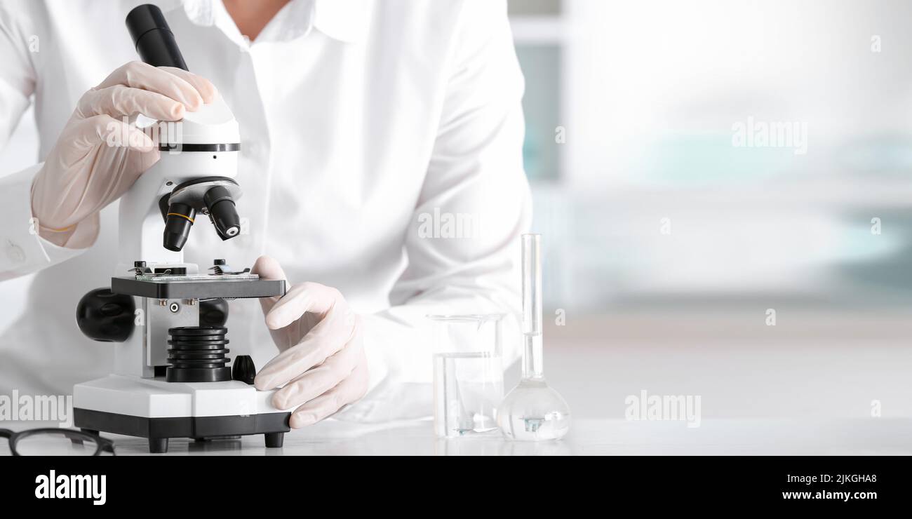 Scientist using microscope in laboratory Stock Photo - Alamy