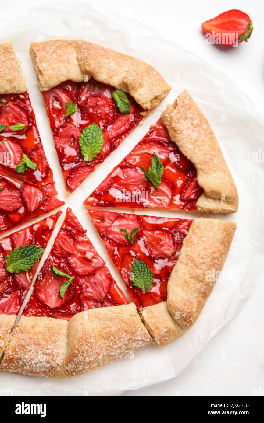 Cut strawberry galette on light background, closeup Stock Photo - Alamy