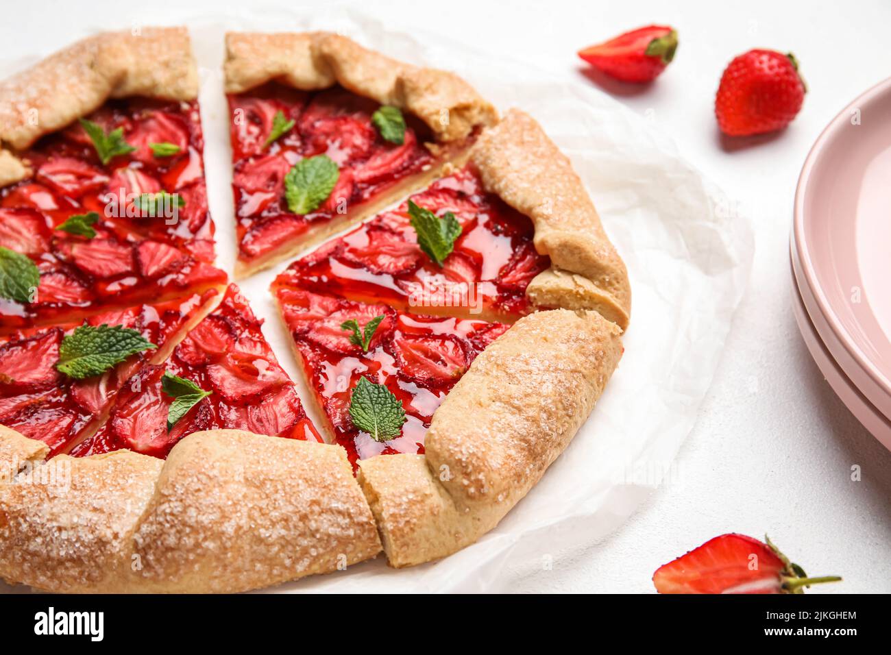 Cut strawberry galette on light background, closeup Stock Photo - Alamy
