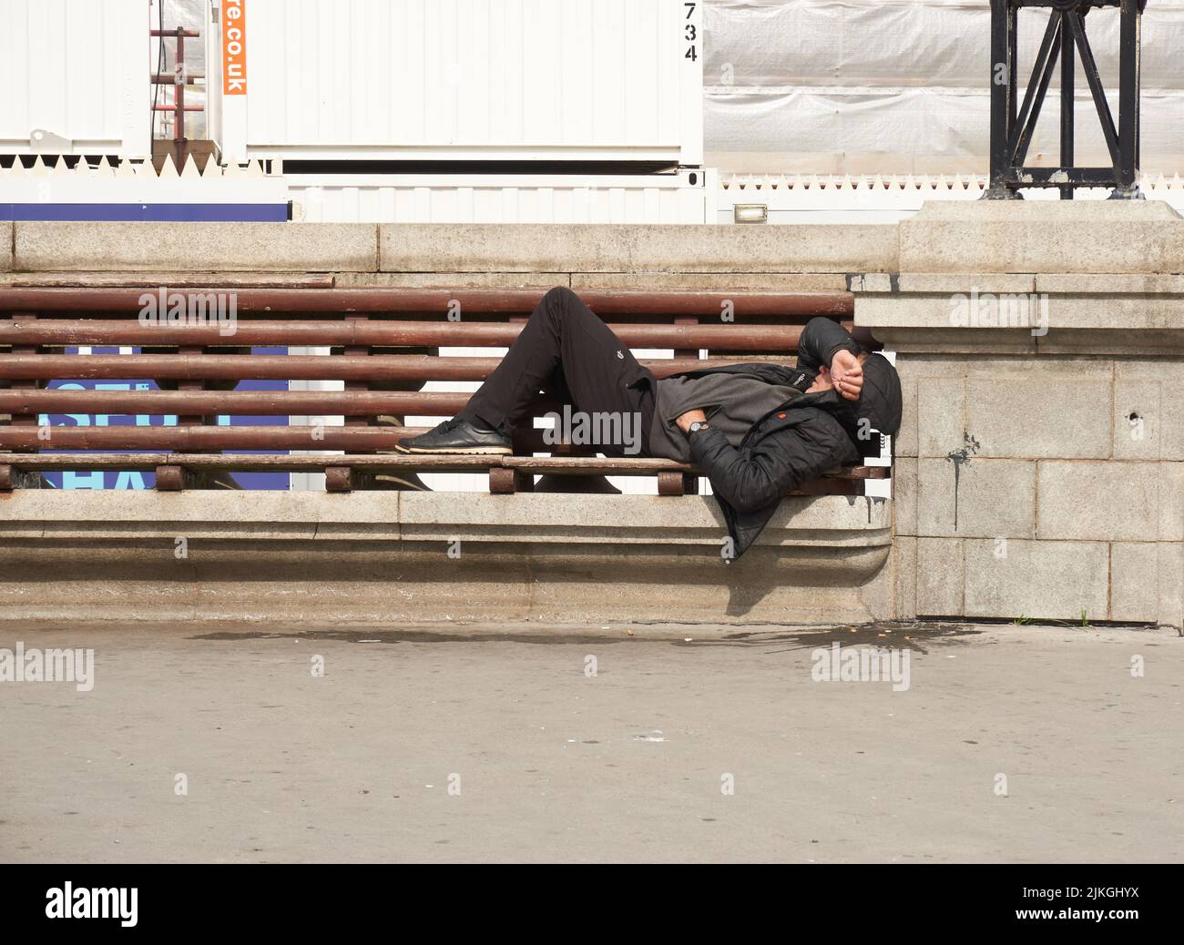 Homeless man sleeping in a city center Stock Photo - Alamy