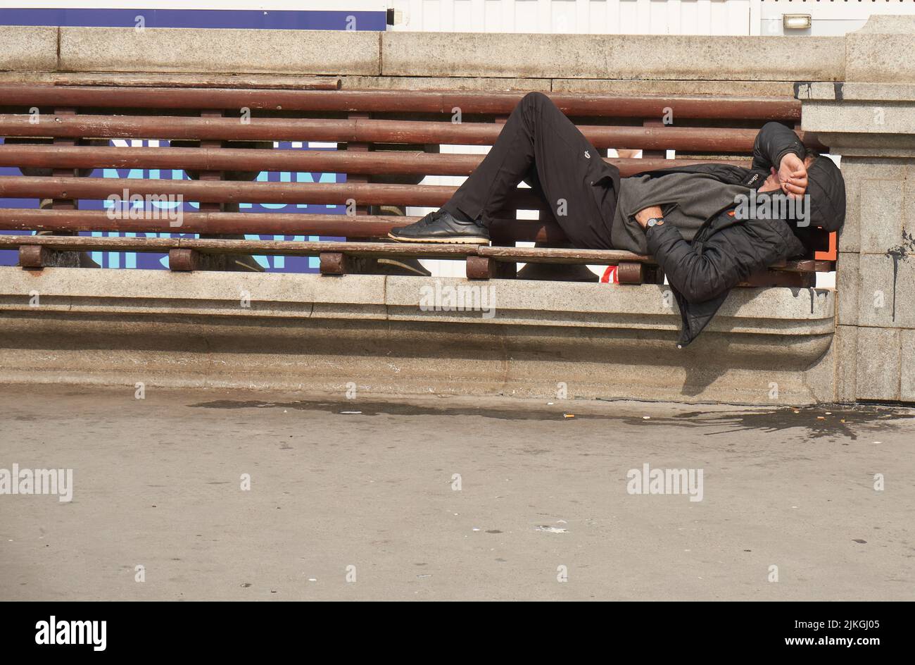 Homeless man sleeping in a city center Stock Photo - Alamy