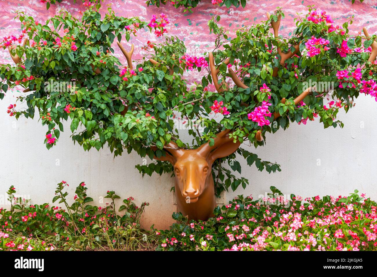 Romantic flower sika deer head and antlers statue in the garden Stock ...