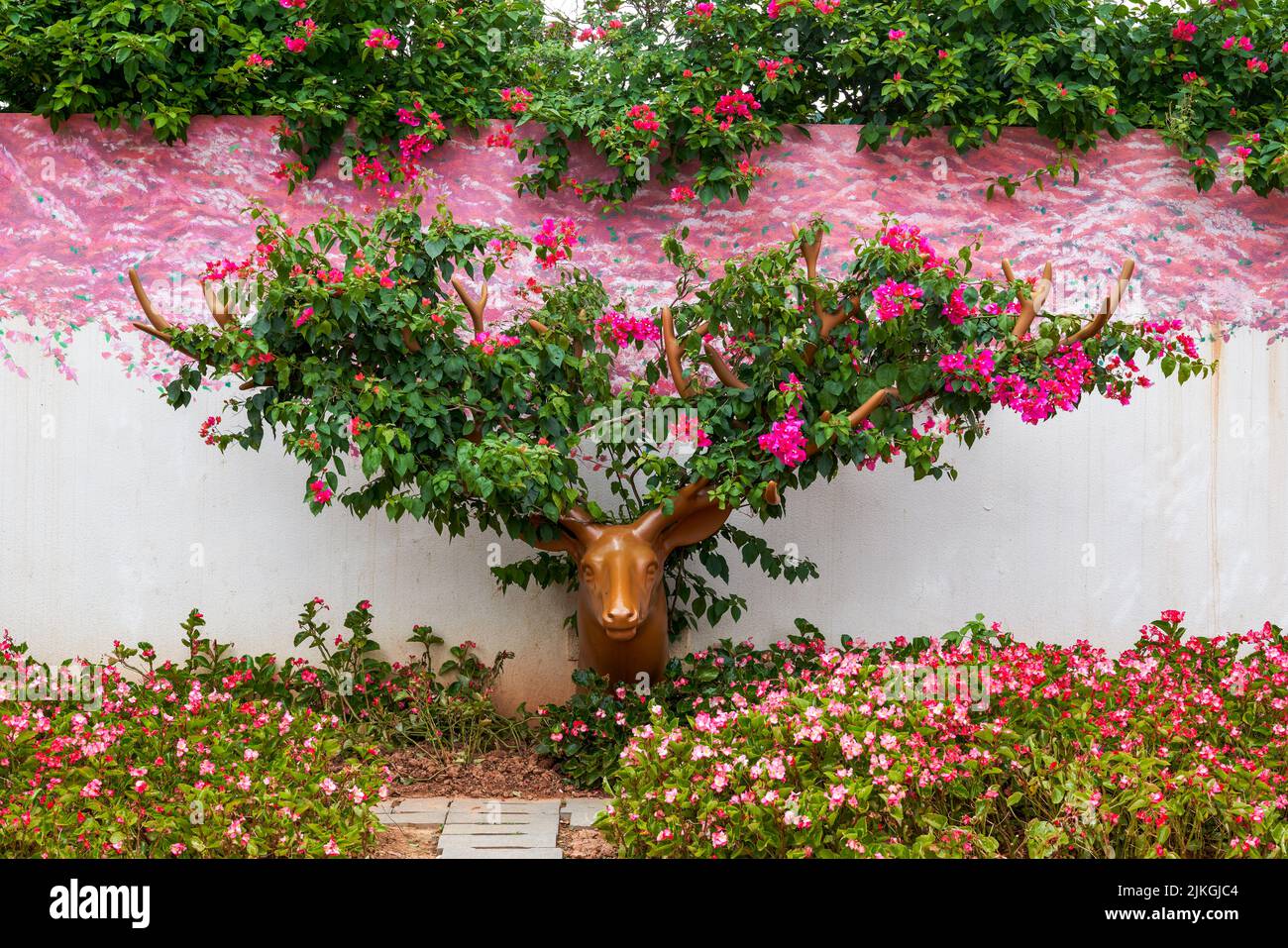 Romantic flower sika deer head and antlers statue in the garden Stock ...