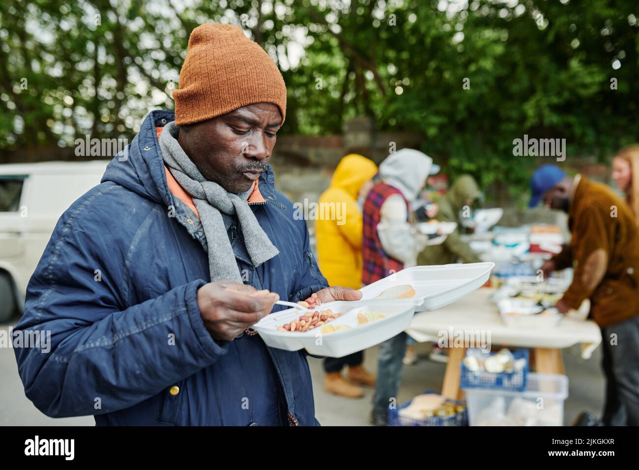 People Giving Food To The Homeless