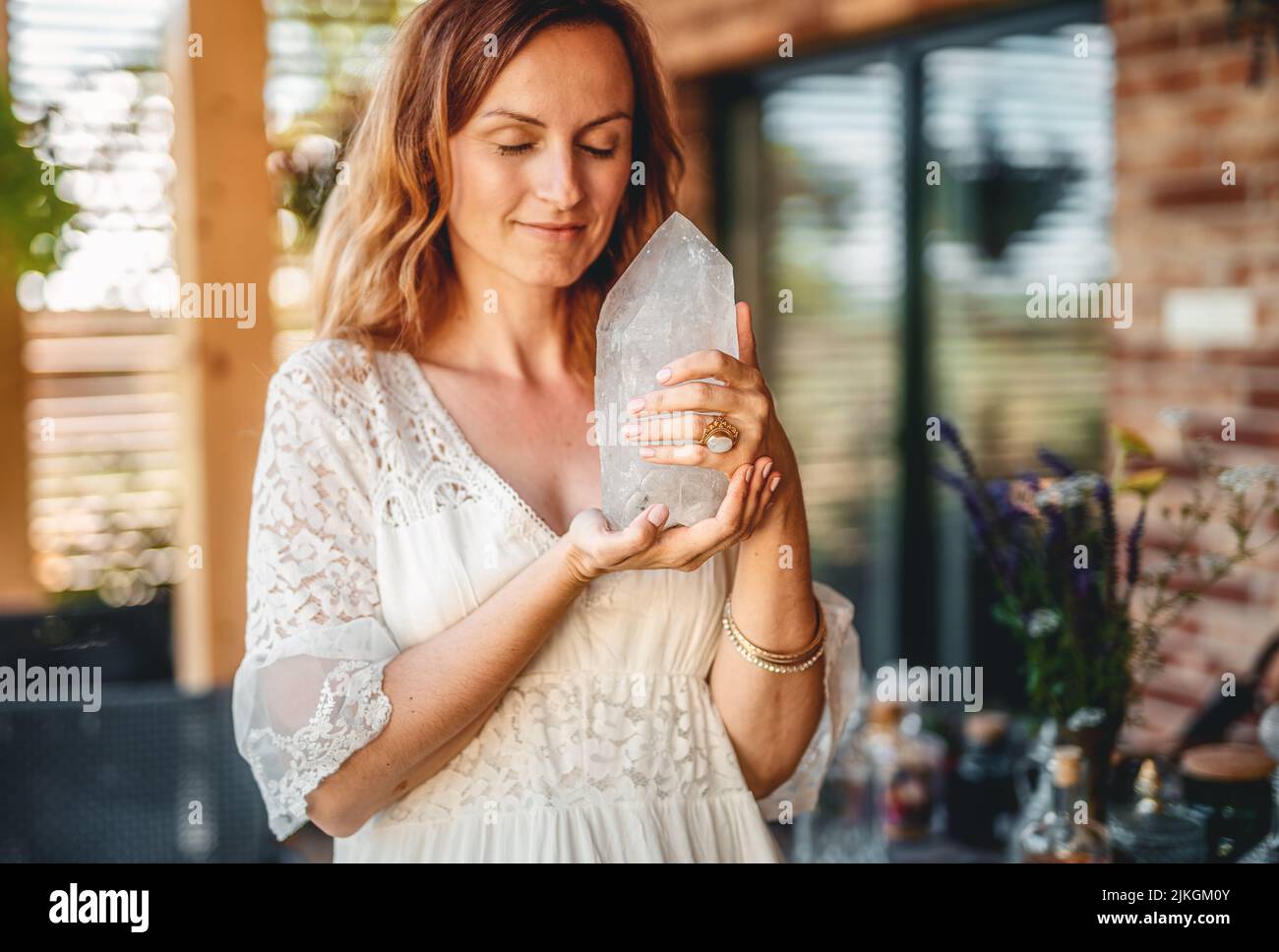 Beautiful woman holding the natural protection crystal Stock Photo - Alamy