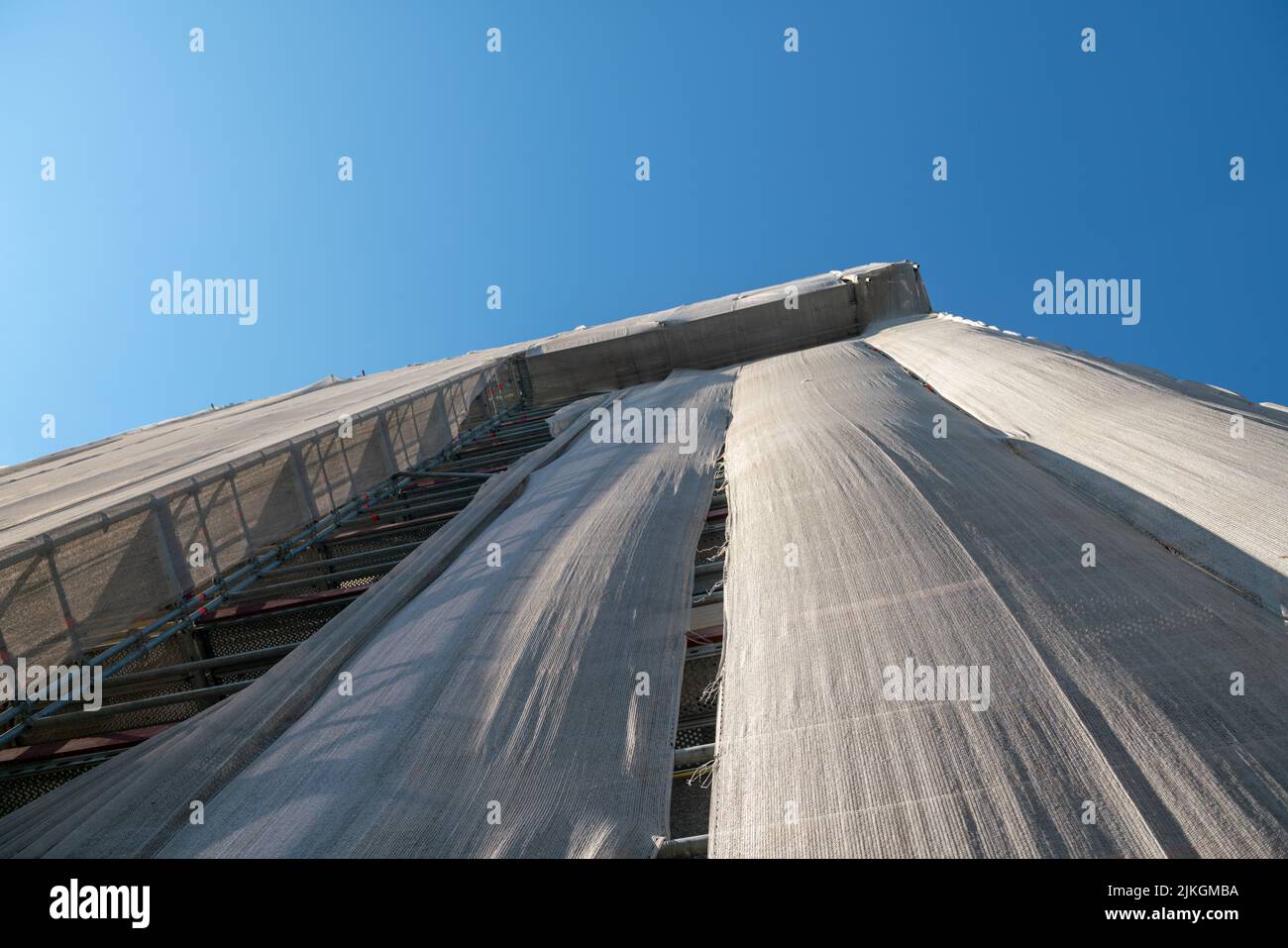 scaffolding: a building covered with a white sheet against the fall of ...
