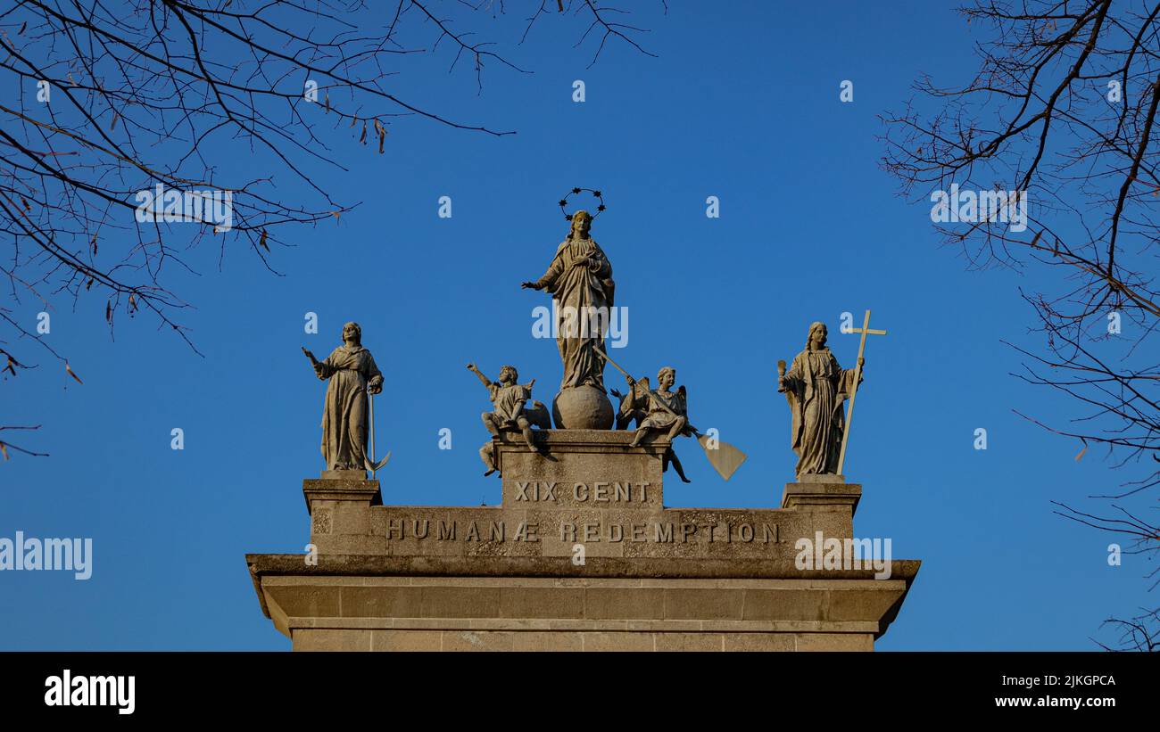 A Low angle shot of a old building with an inscription and sculptures ...