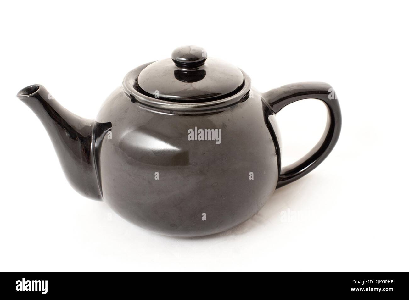 Shiny isolated bulbous ceramic teapot for serving and brewing tea, side ...