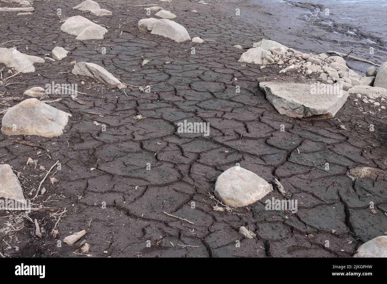 A high angle shot of a cracked muddy ground covered with rocks Stock ...