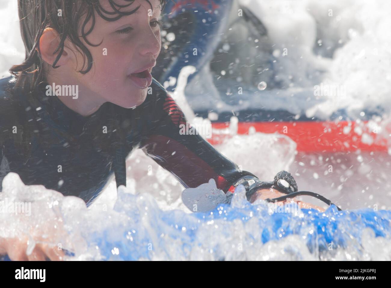 Boy boogie boarding at West Dale beach, Pembrokeshire, Wales, UK Stock ...