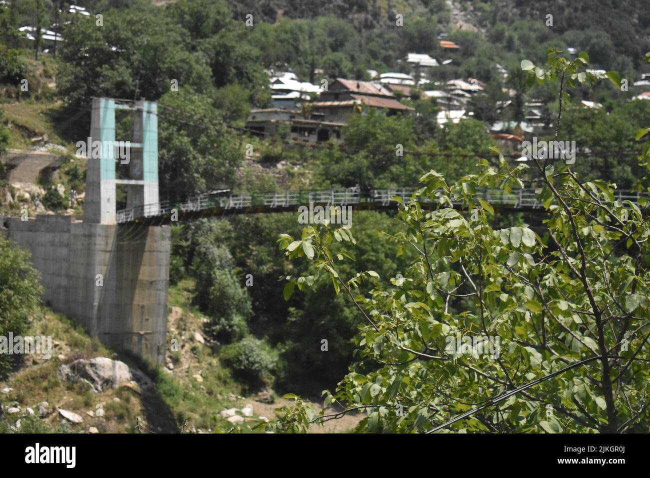 A view of the blue bridge surrounded by beautiful nature in Azad Jammu ...