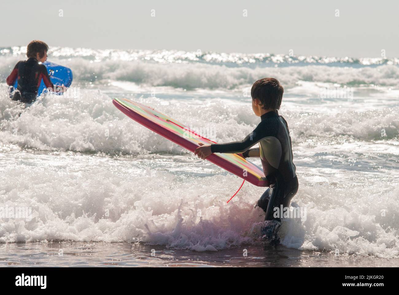 Boy boogie boarding at West Dale beach, Pembrokeshire, Wales, UK Stock ...