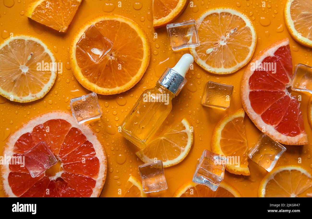 Essential oil of orange on a yellow background. Selective focus. Spa ...