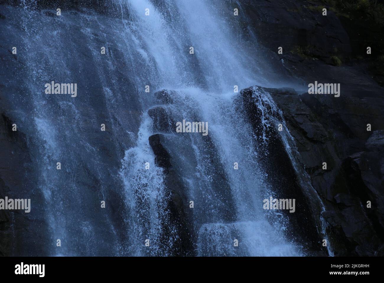 A low angle view of a beautiful waterfall flowing in the forest Stock ...