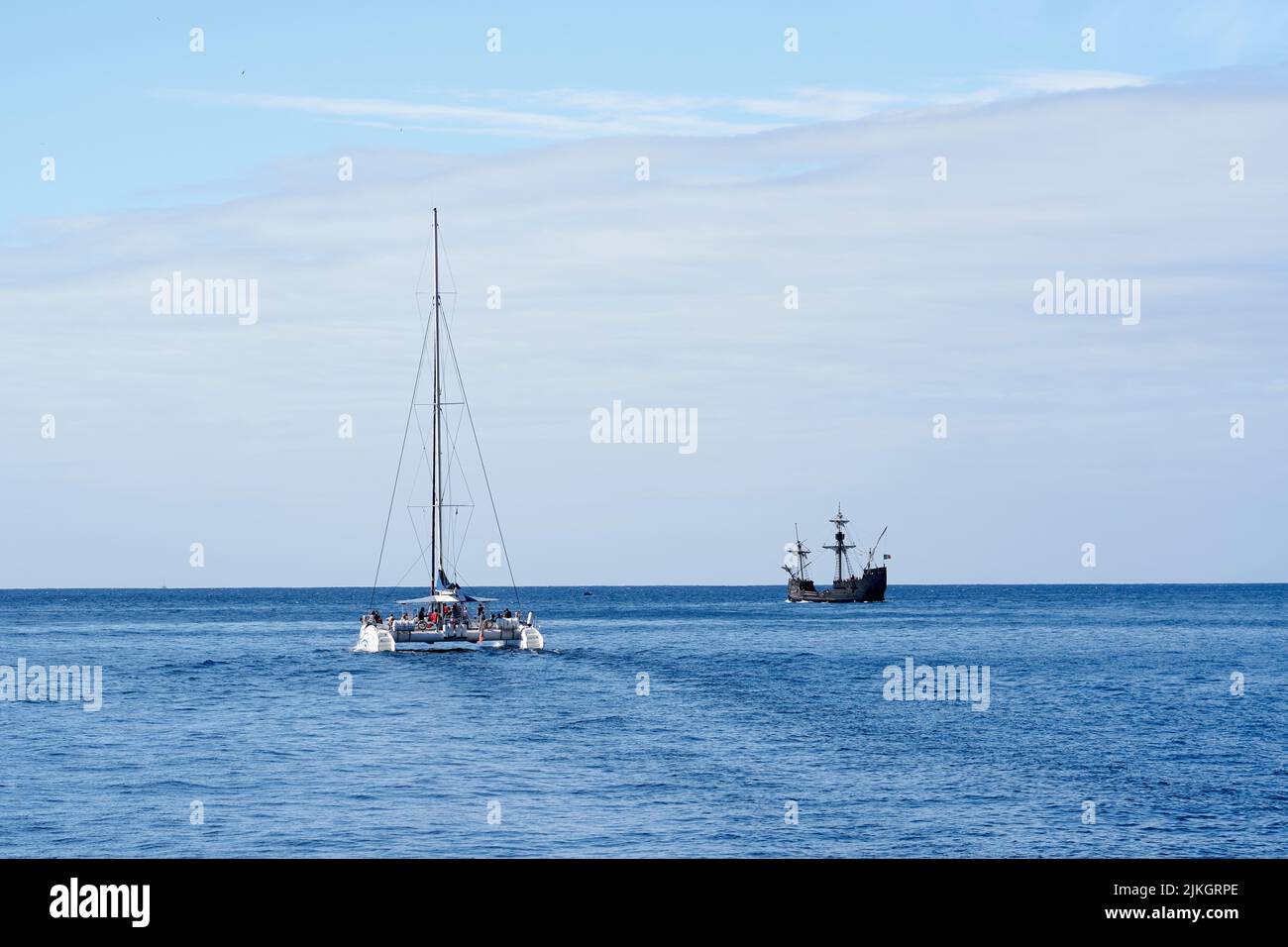 The catamaran and pirate ships meeting in the vast open ocean Stock ...