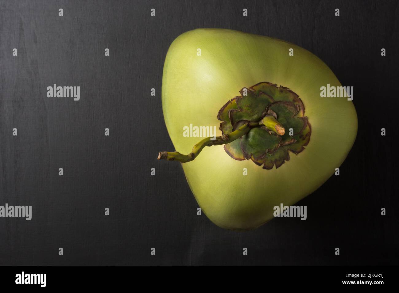 close-up of young green coconut on black table top, healthy tropical ...