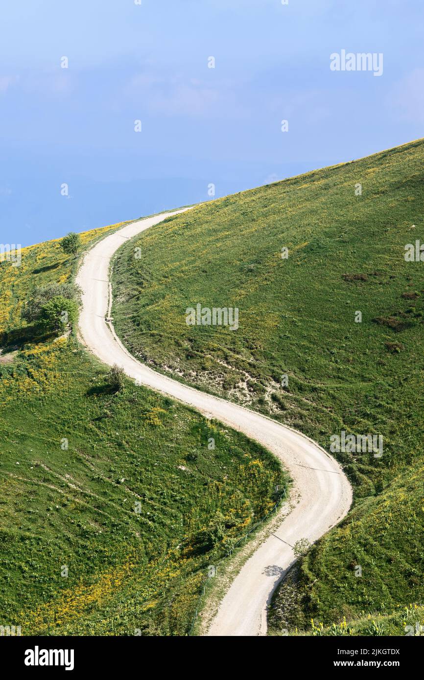 S-shaped country road winding along the slopes of a mountain and ...