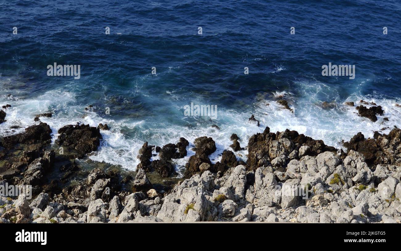 An aerial view of sea waves breaking rocky beach Stock Photo - Alamy