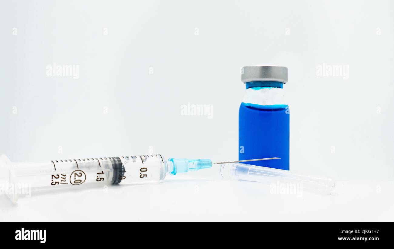 A syringe and blue vaccine tube isolated on the white background Stock ...