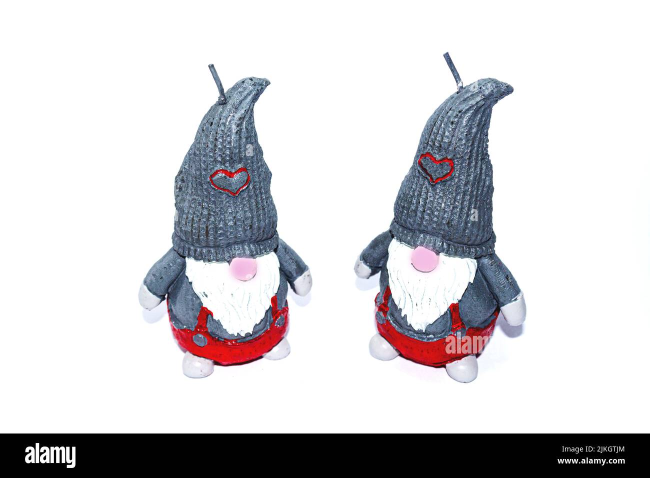 A closeup of two dwarfs Santa Claus candles isolated in white ...