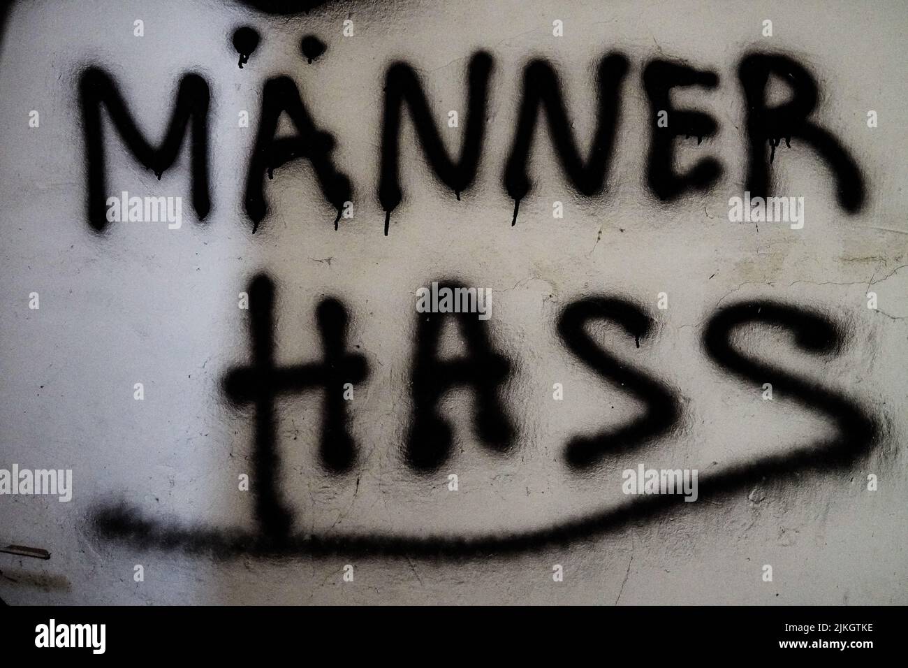 A Graffiti word "Maennerhass" ("misandry") sprayed on a wall in a ...