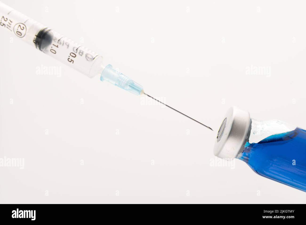 A syringe and blue vaccine tube isolated on the white background Stock ...