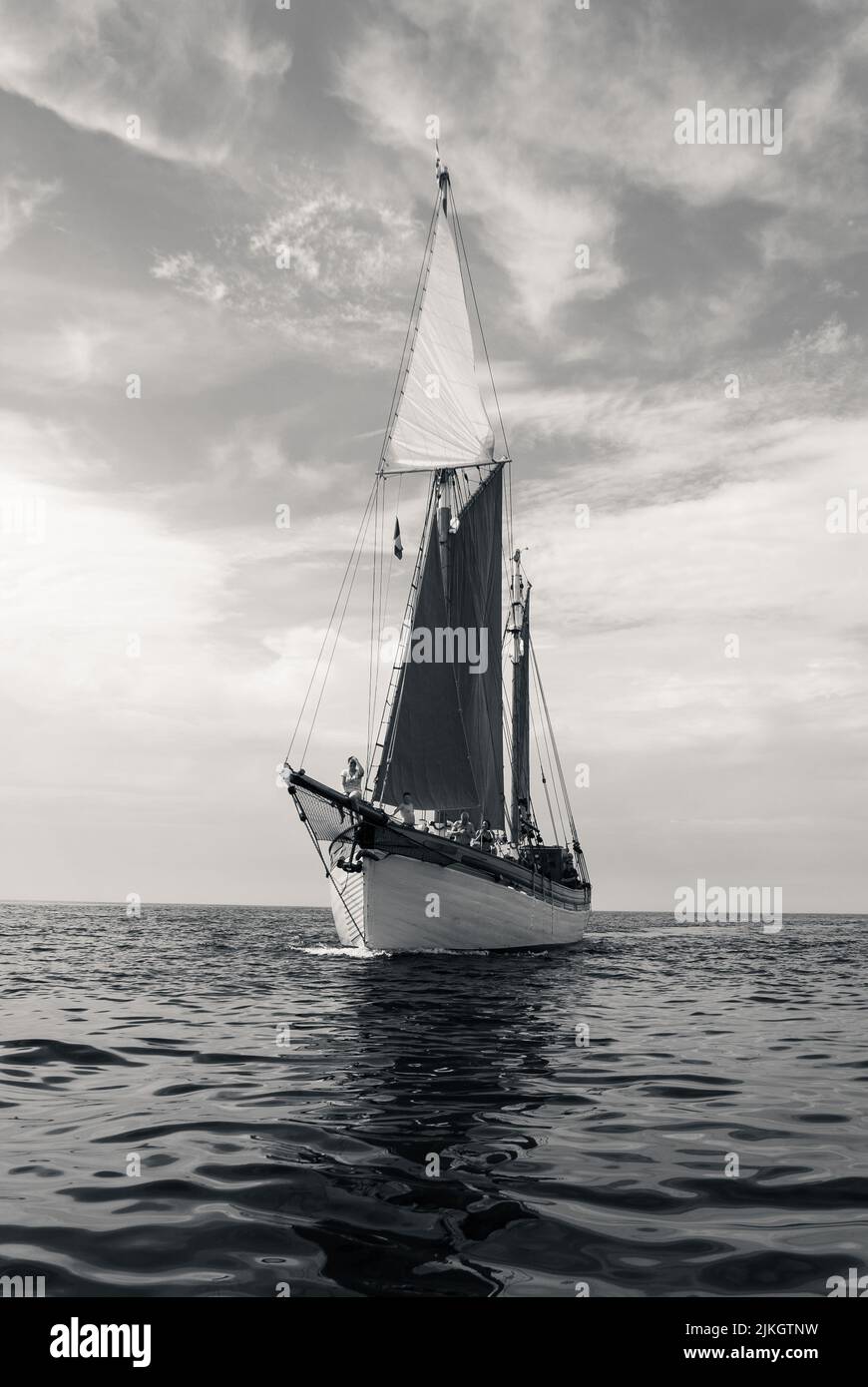 A grayscale of a sailboat in the sea in Sardinia, Italy Stock Photo - Alamy
