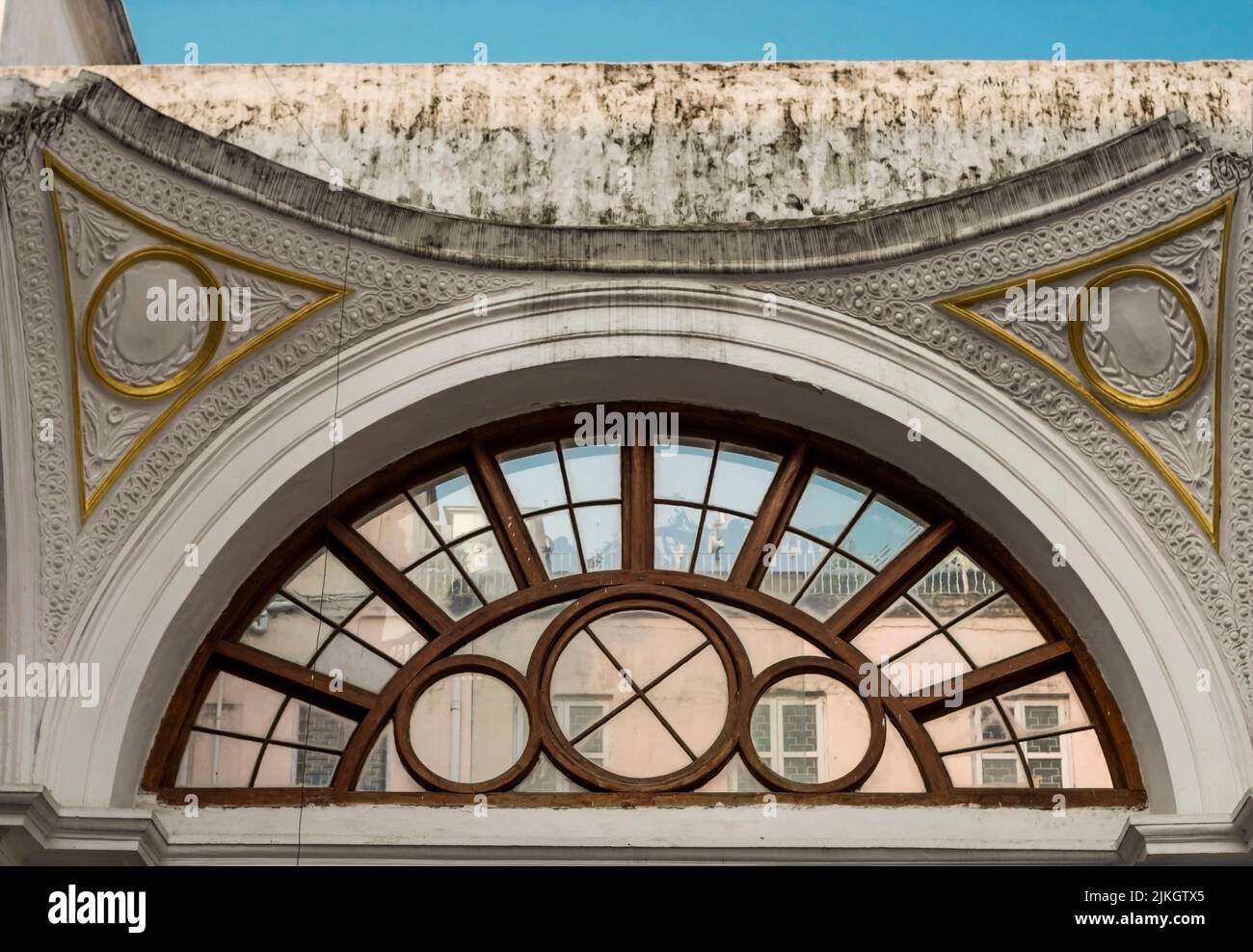 A semi circle window with wooden frame lines in a vintage style ...