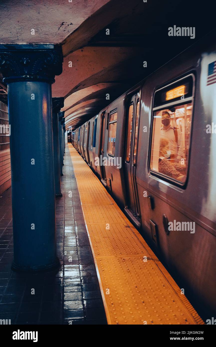 A vertical shot of a full train driving in subway Stock Photo - Alamy