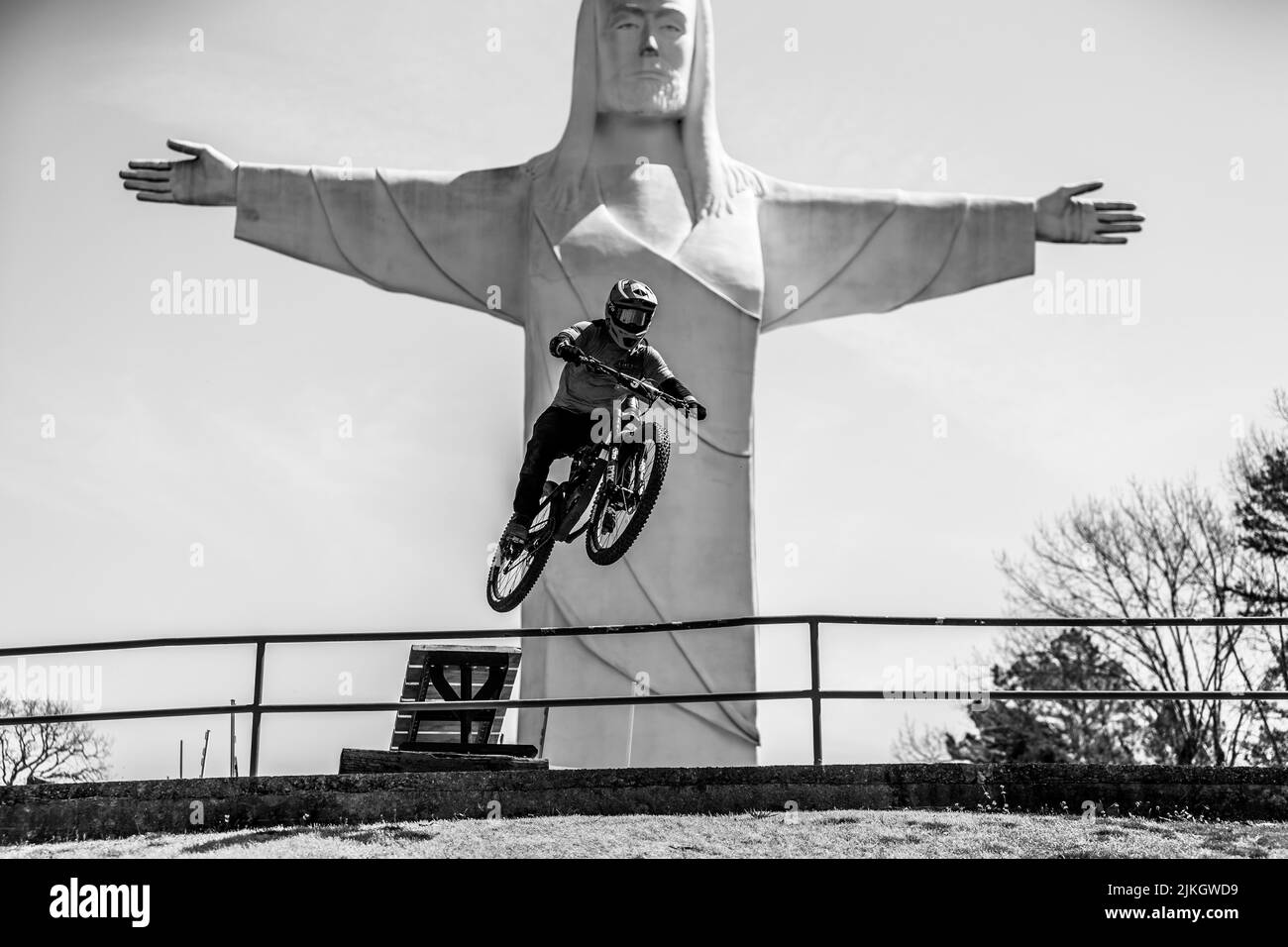 A grayscale of a biker doing tricks during the enduro competition in ...