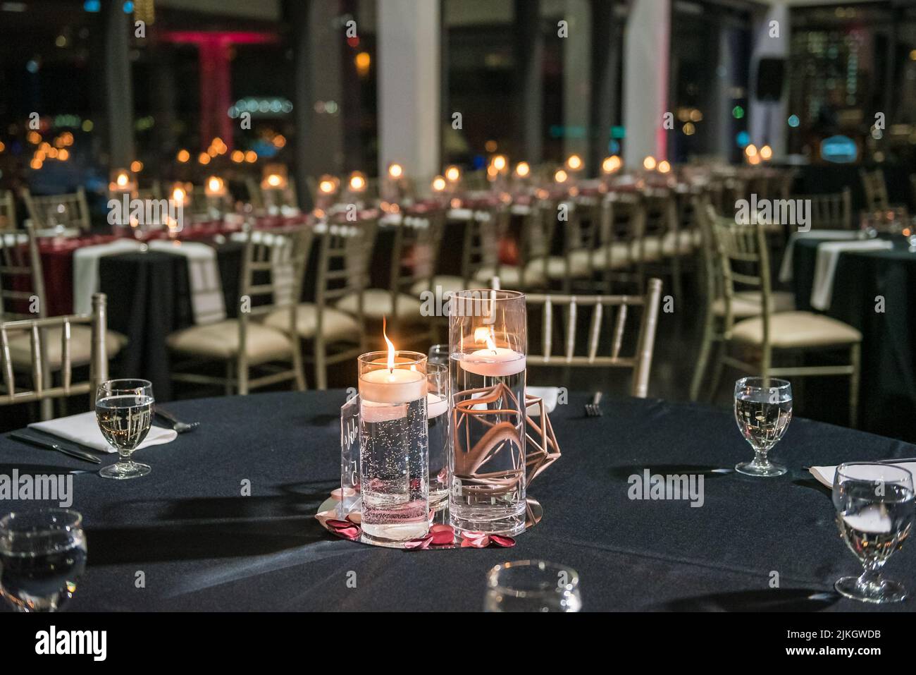 Night time at a banquet wedding event hall featuring black and burgundy ...