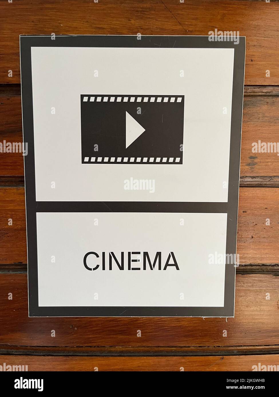 A "CINEMA" sign with a film and 'play' symbolism indicating a theatre ...