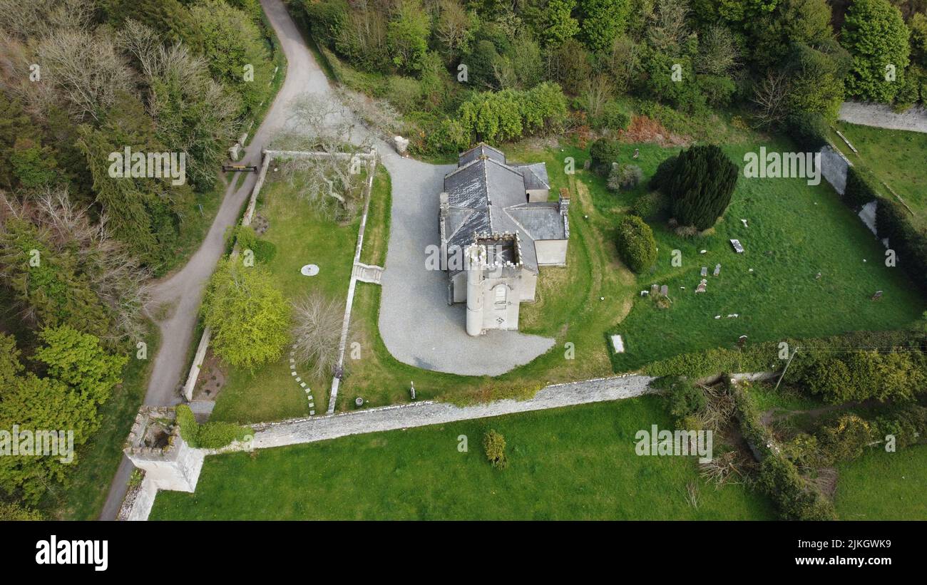 An aerial view of Donadea church surrounded by growing lush trees and ...