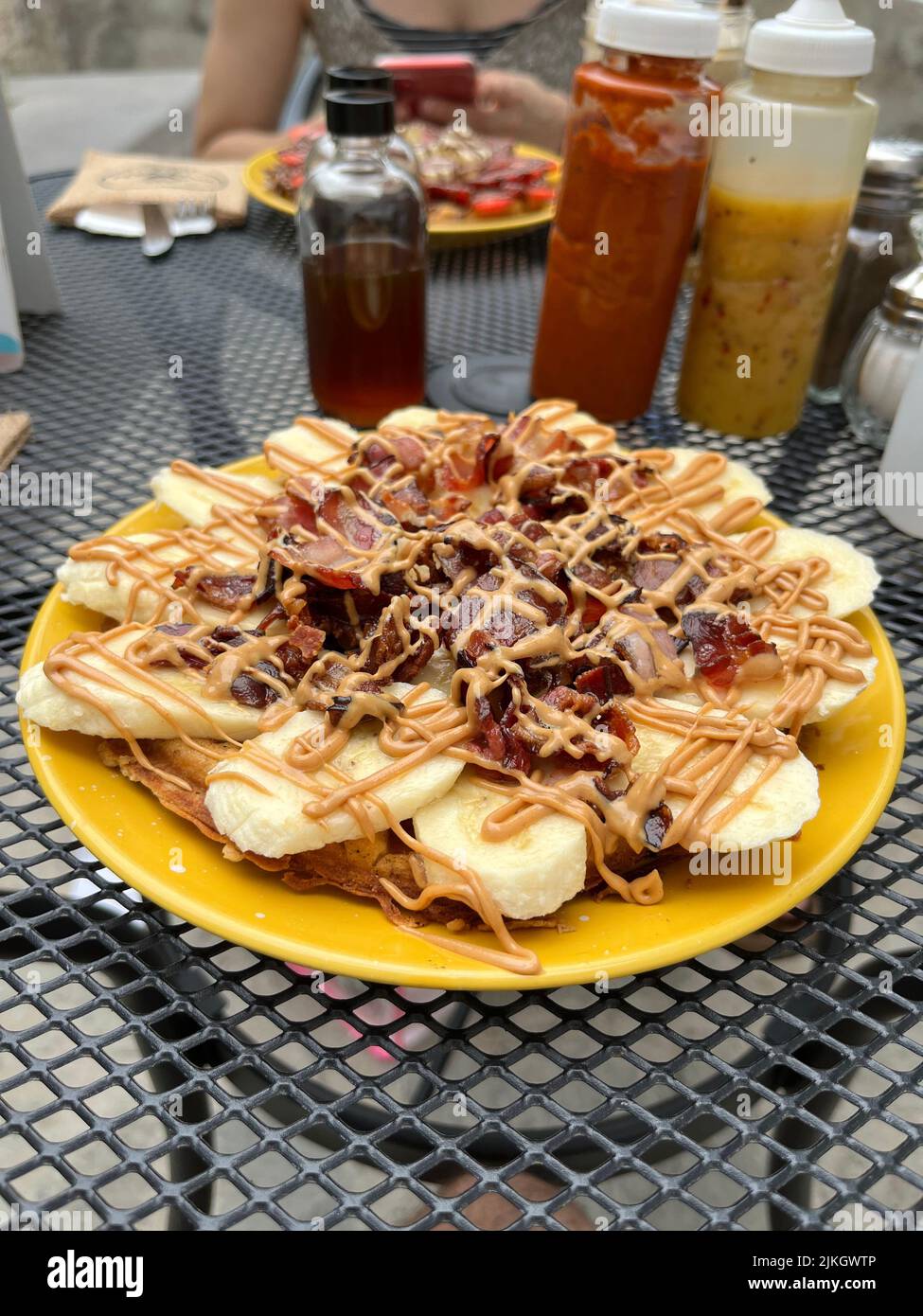 A delicious bacon, peanut butter, banana, waffle breakfast on a metal ...