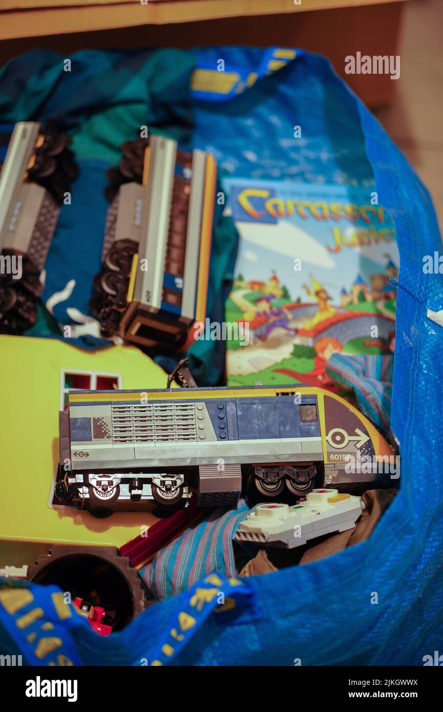 Some lego trains lying insode a bag full pf toys and book Stock Photo ...