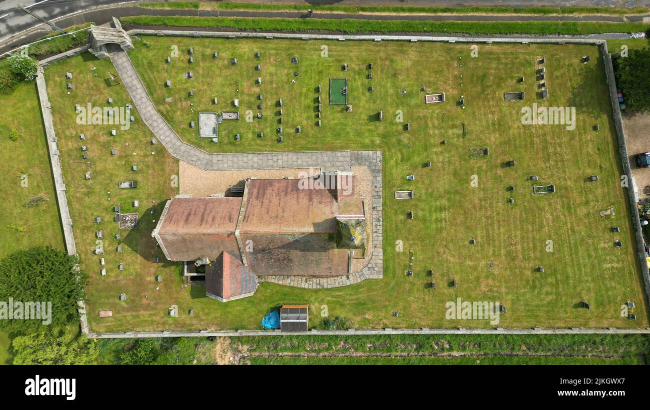 An aerial top view of Village Church surrounded by cemetery and ...