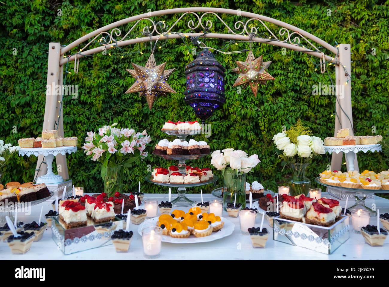 A decorated table with plates of cakes at a wedding reception Stock ...