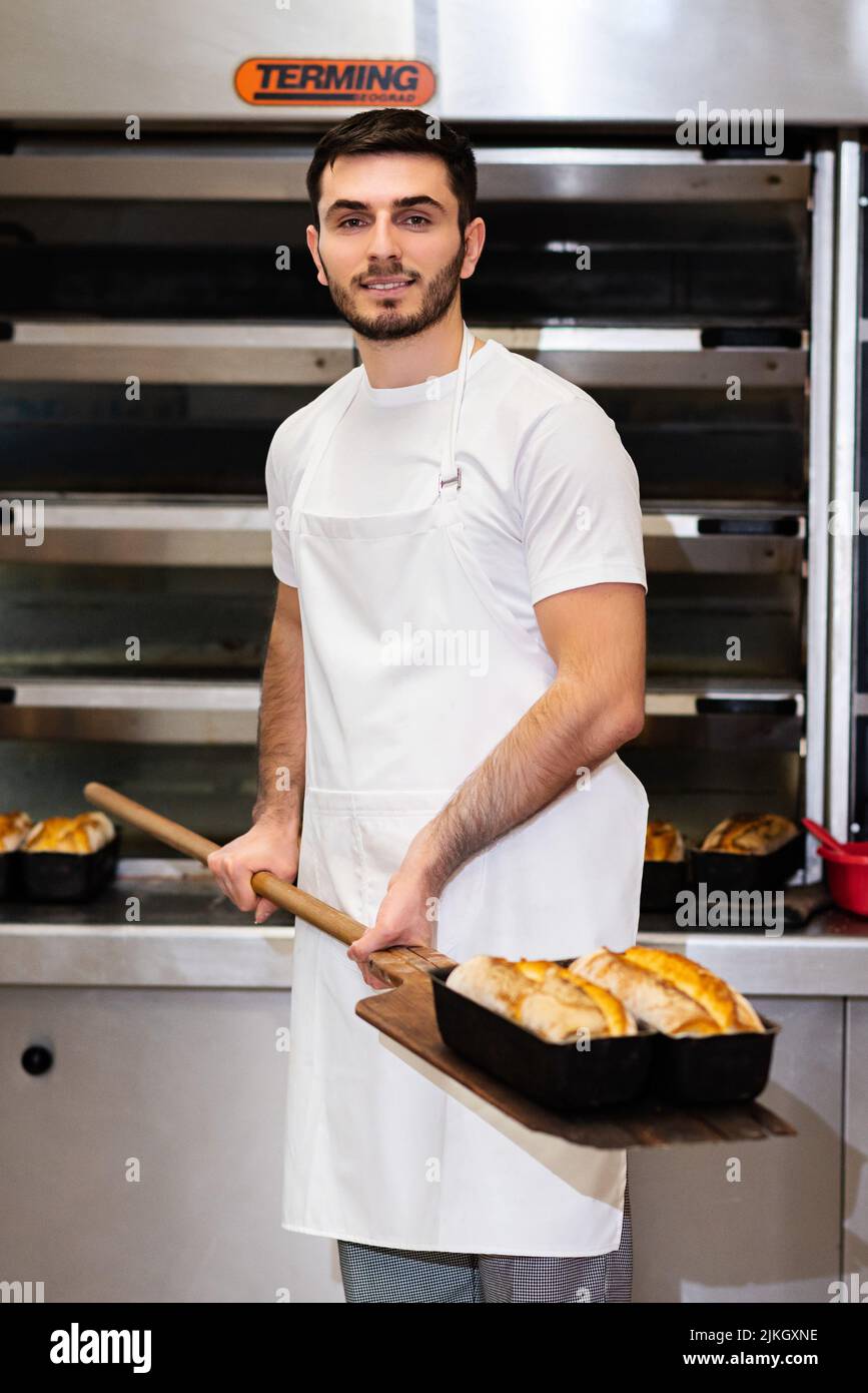 Taking bread out of the oven hi-res stock photography and images - Alamy