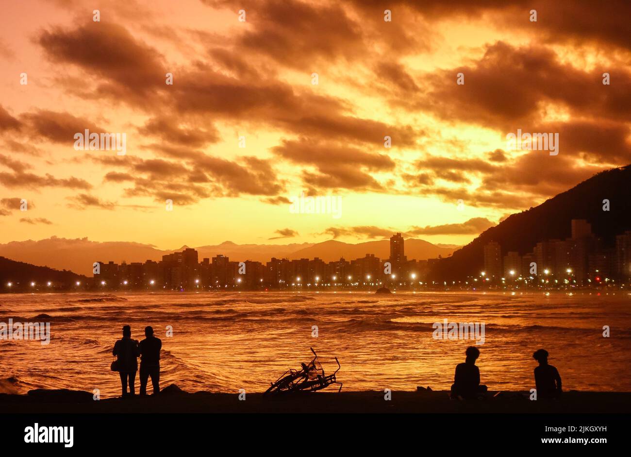 Santos, Brazil: people having fun at seacoast at sunset. Travel and ...