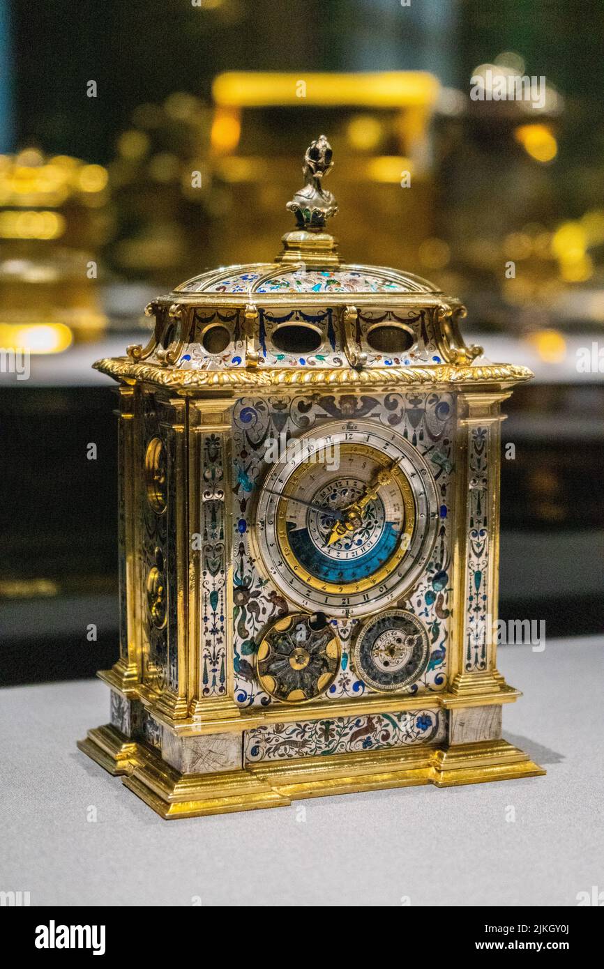 A vertical shot of a vintage table clock made by David Altenstetter ...