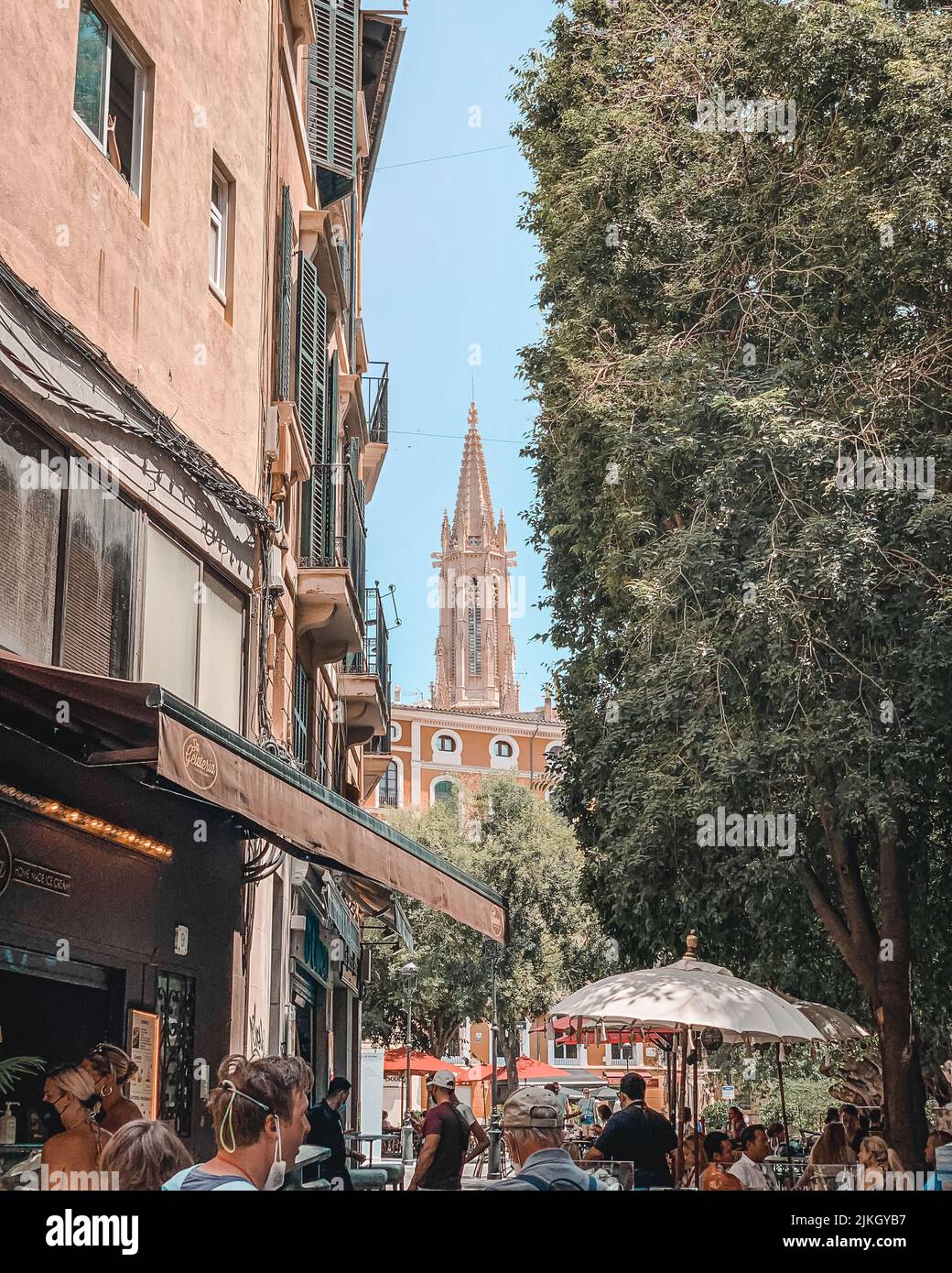 A beautiful view of people on the street with old buildings in Palma de ...