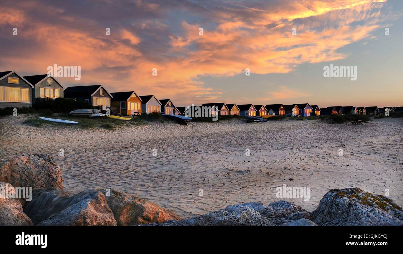 The mesmerizing sunrise with beach huts over a Mudeford Quey ...